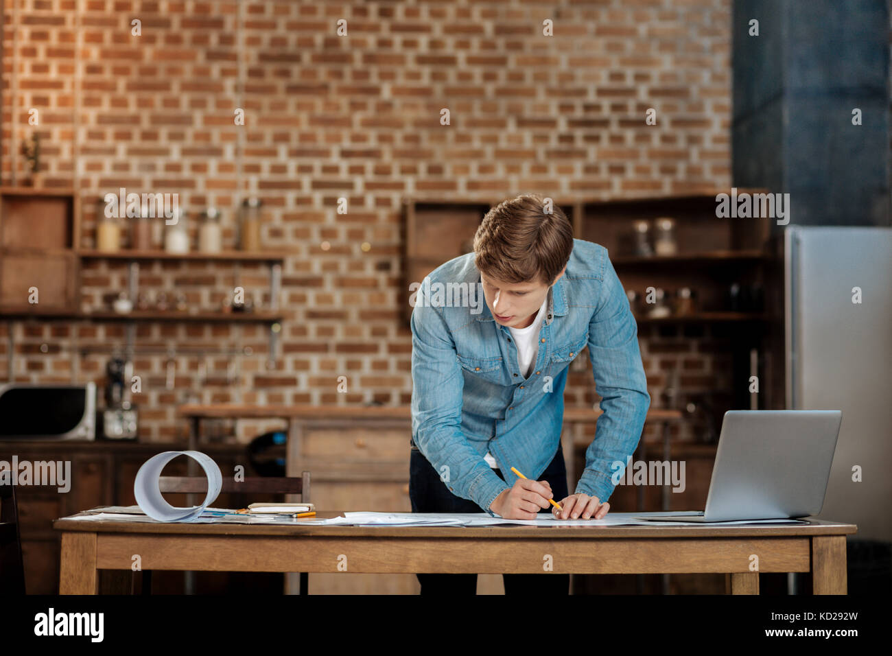 Young engineer working on a new blueprint Stock Photo - Alamy