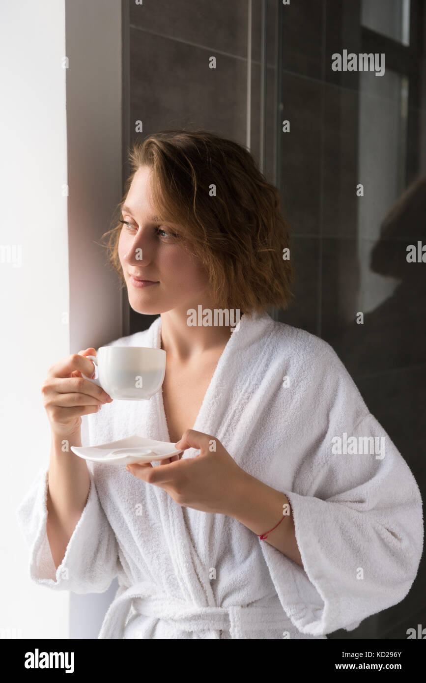 girl in bathrobe drinking coffee Stock Photo - Alamy