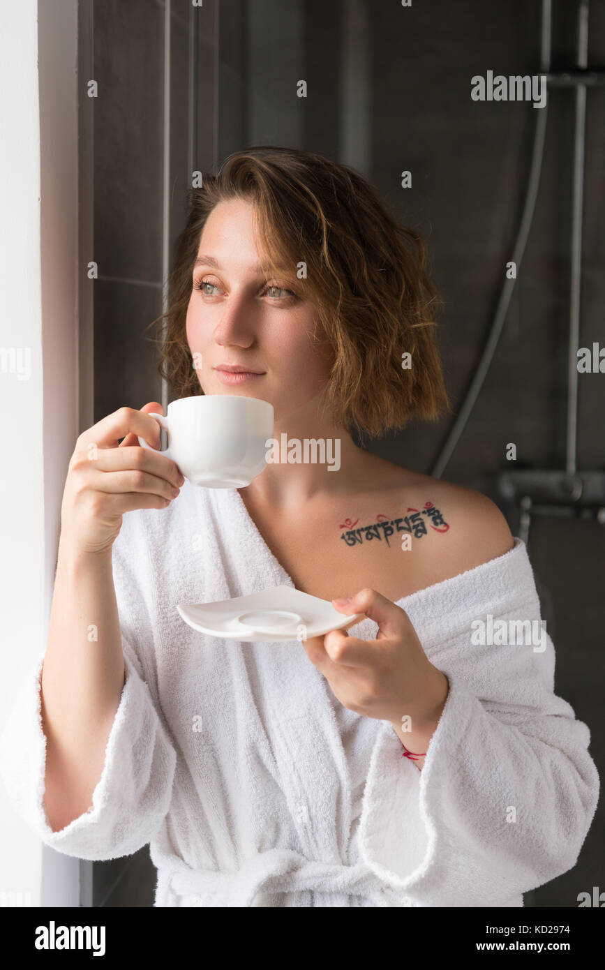 girl in bathrobe drinking coffee Stock Photo - Alamy