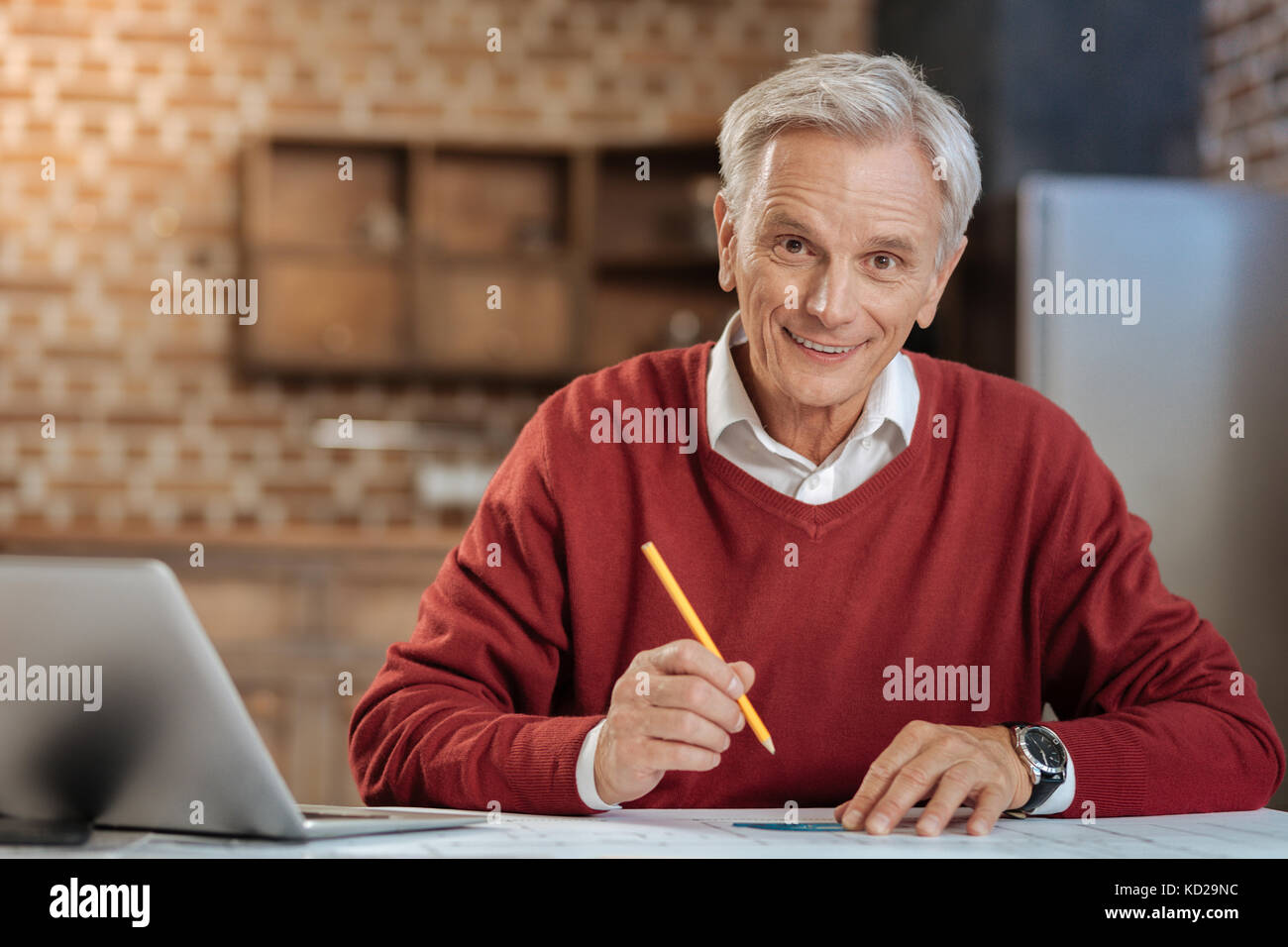 Cheerful senior engineer posing while drawing blueprint Stock Photo - Alamy