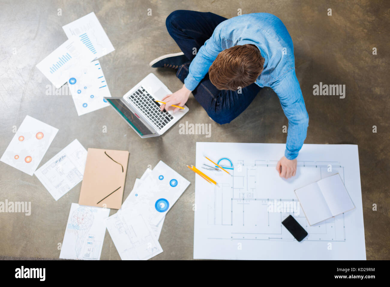 Top view of brown-haired engineer working on the floor Stock Photo - Alamy