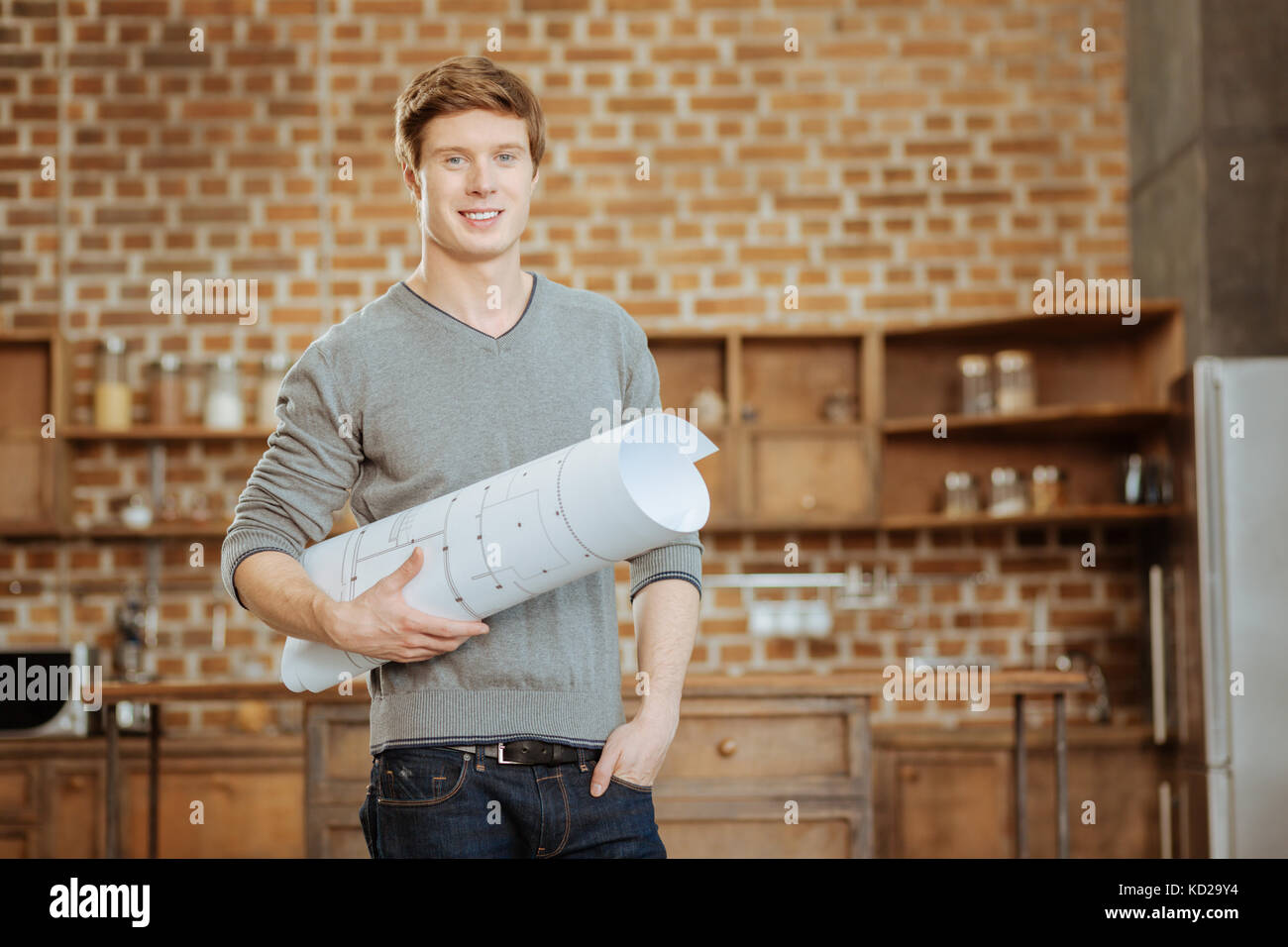 Well-built engineer posing with a blueprint Stock Photo - Alamy