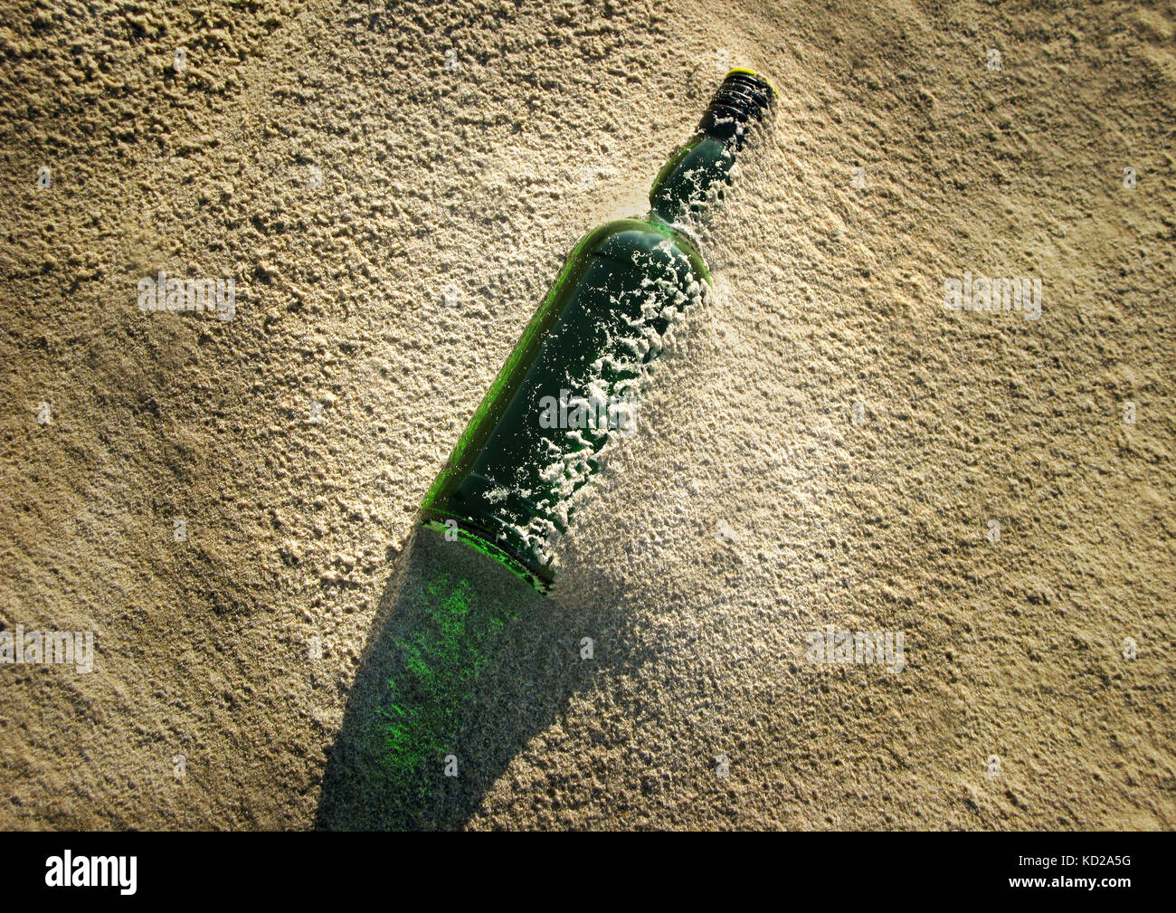 Empty bottle lying on the beach after the tide Stock Photo - Alamy