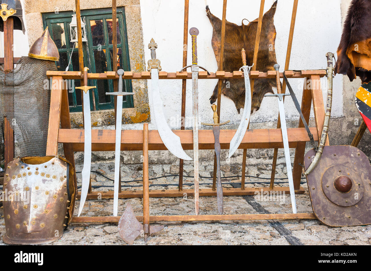 medieval shields, helm and weapons in a medieval fair Stock Photo - Alamy