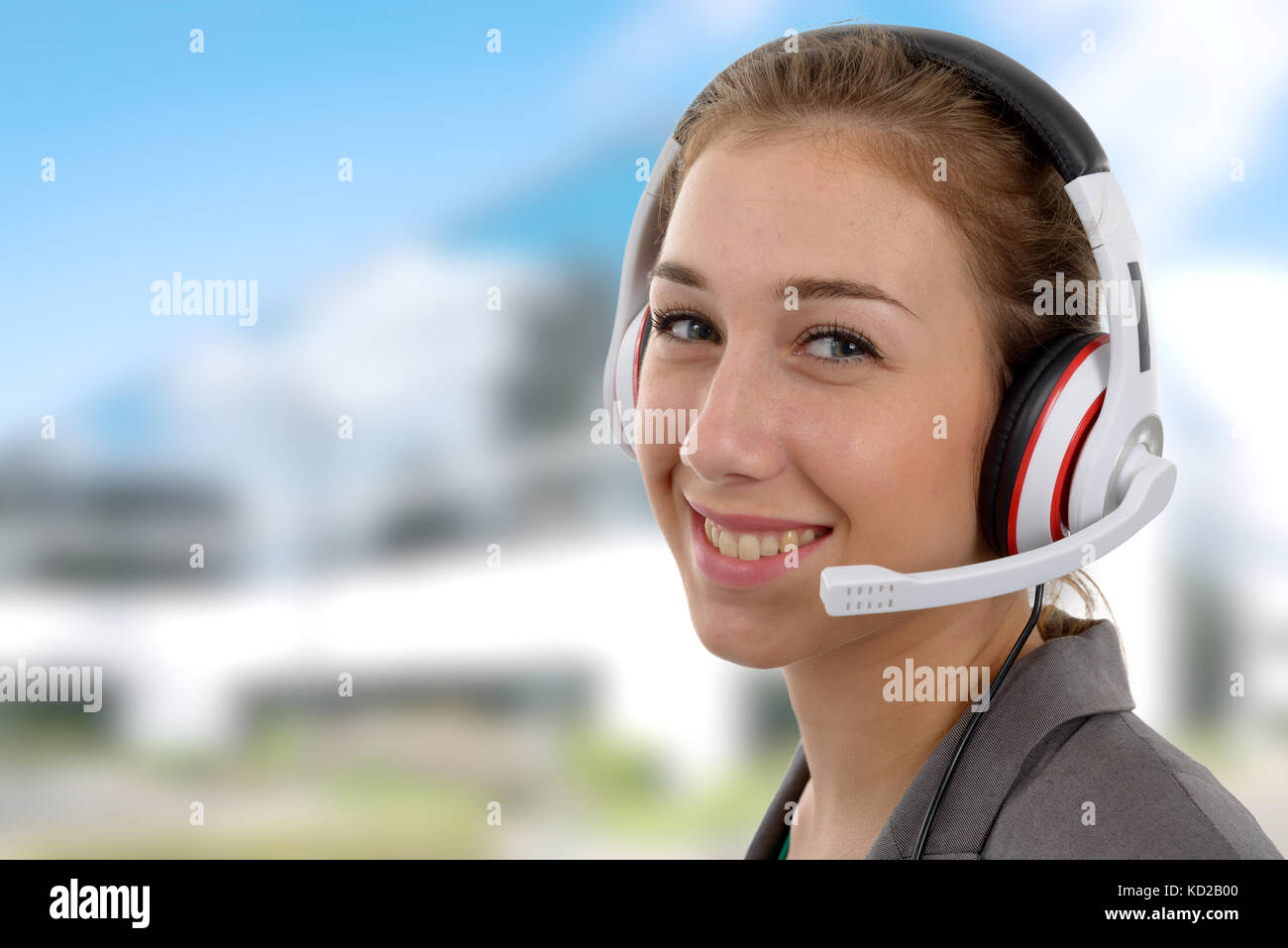 a beautiful smiling young woman with a headset Stock Photo - Alamy