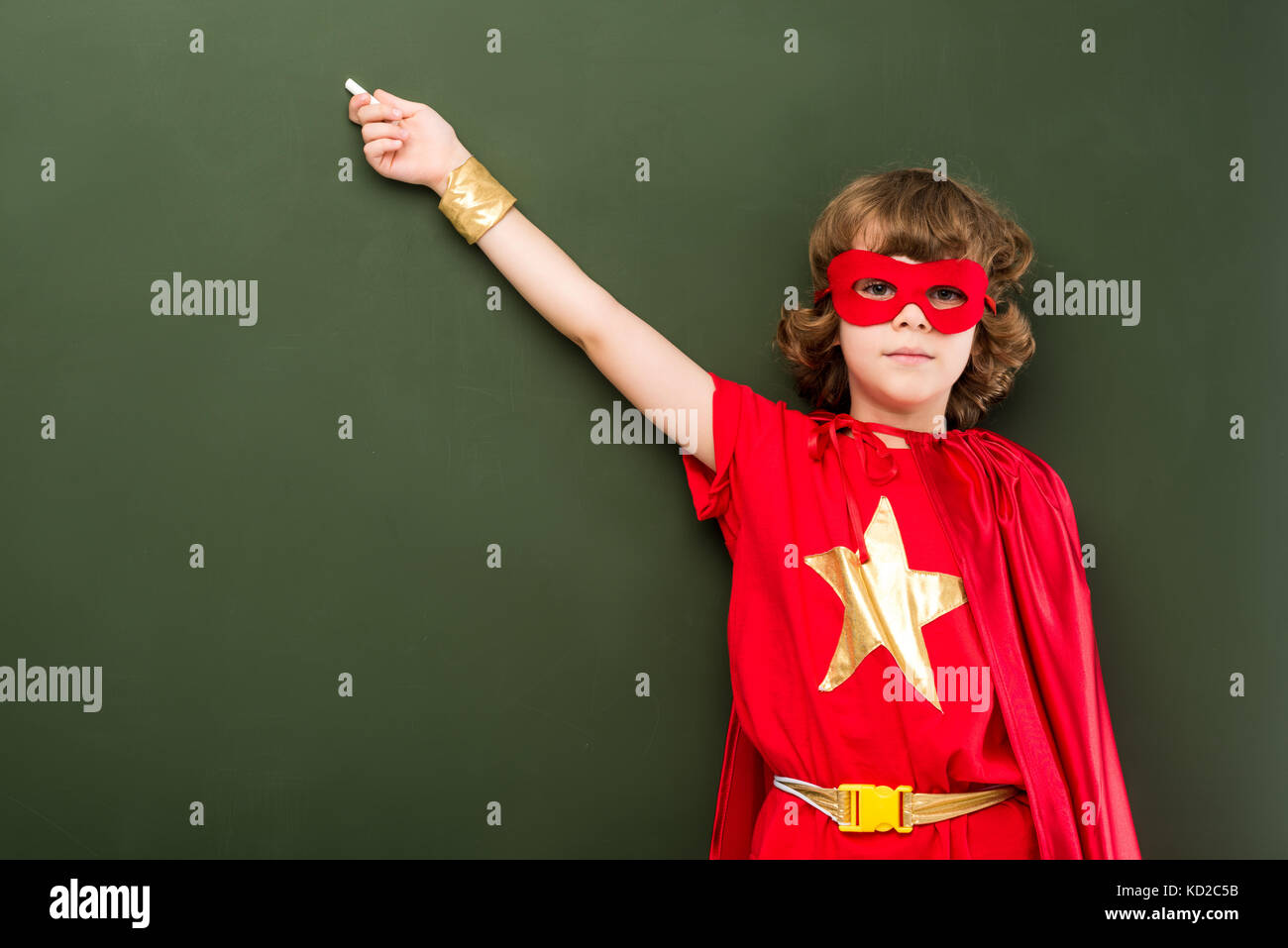 superhero pointing on chalkboard Stock Photo - Alamy