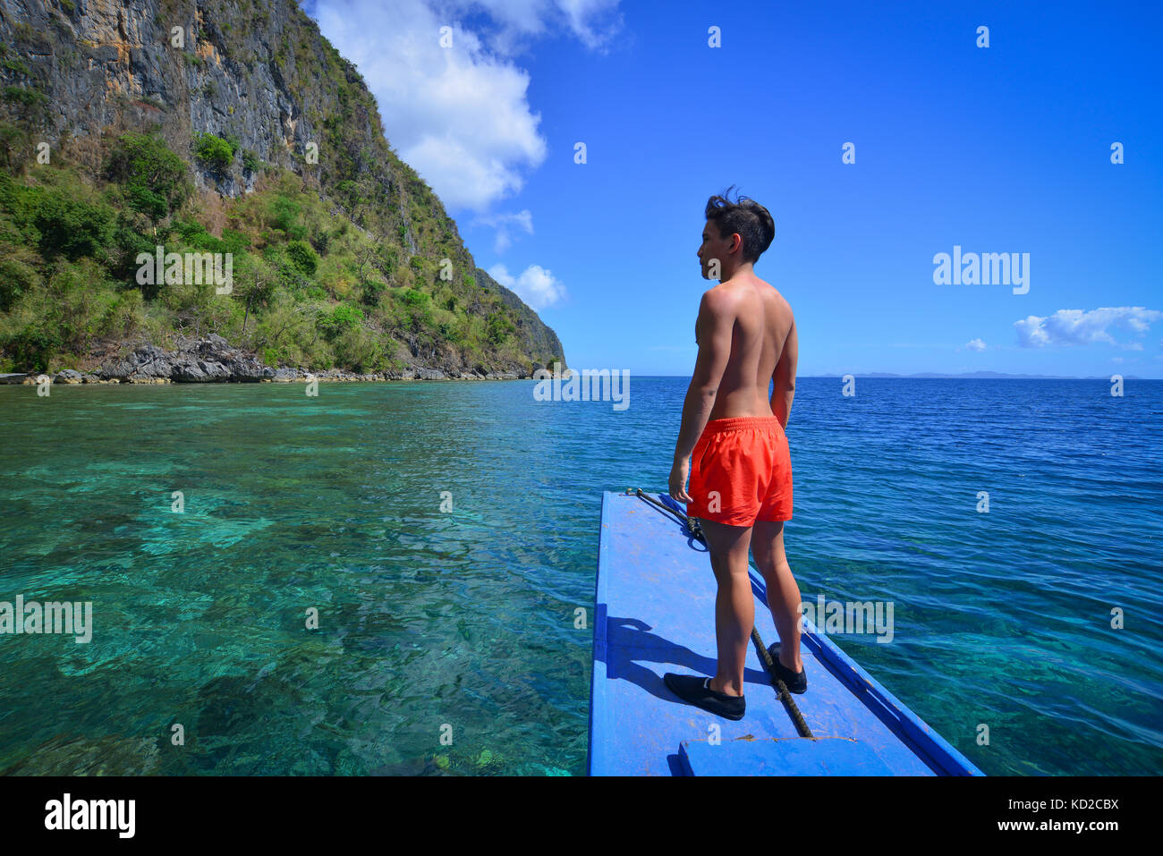 A man standing on wooden boat in Coron Island, Philippines. Coron is ...