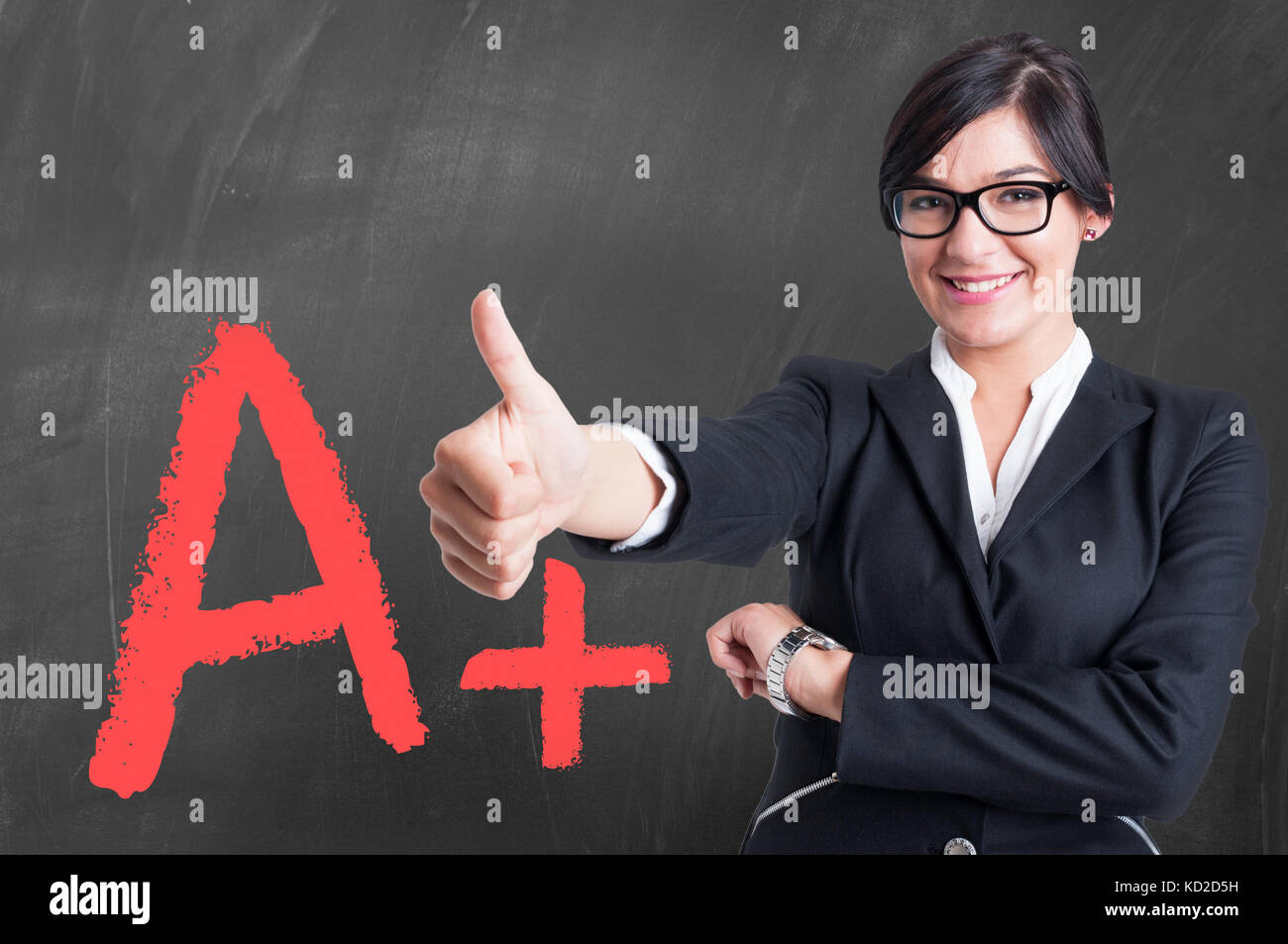 Happy young professor giving a good mark and rising thumb up Stock ...