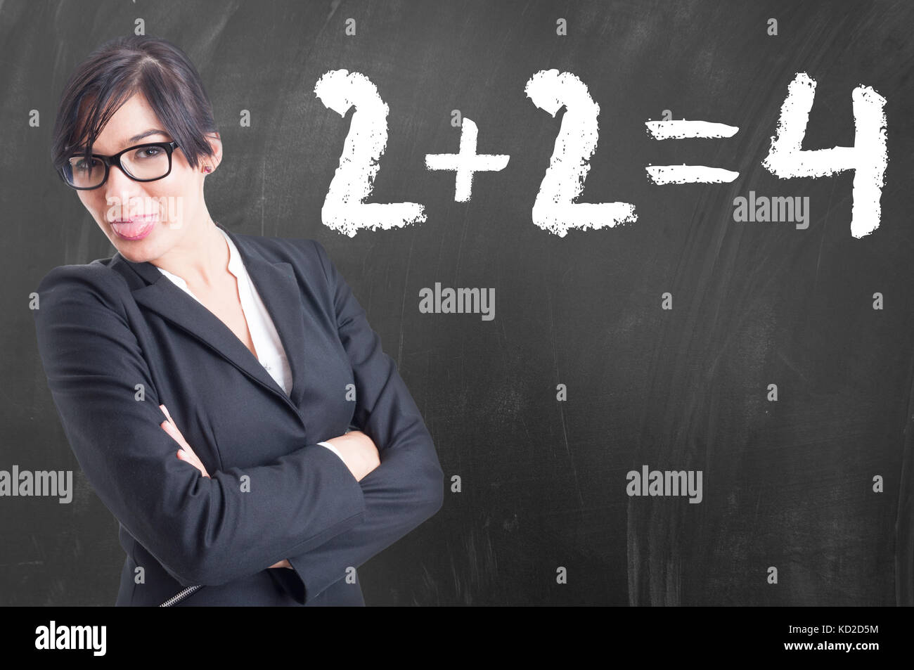 Young math teacher writing numbers on the chalkboard as concept of ...