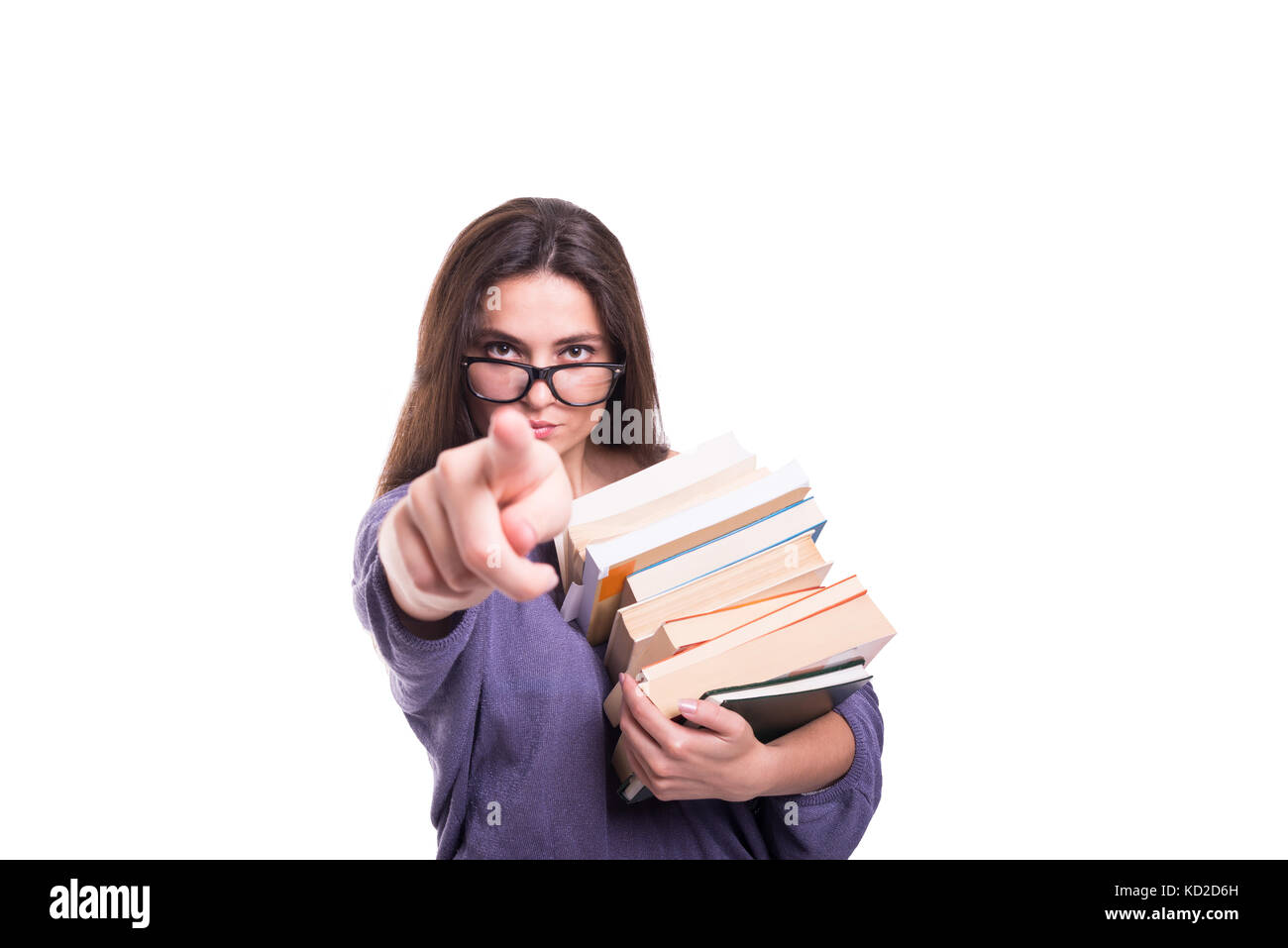 Pretty girl student with many books pointing finger at you isolated on ...