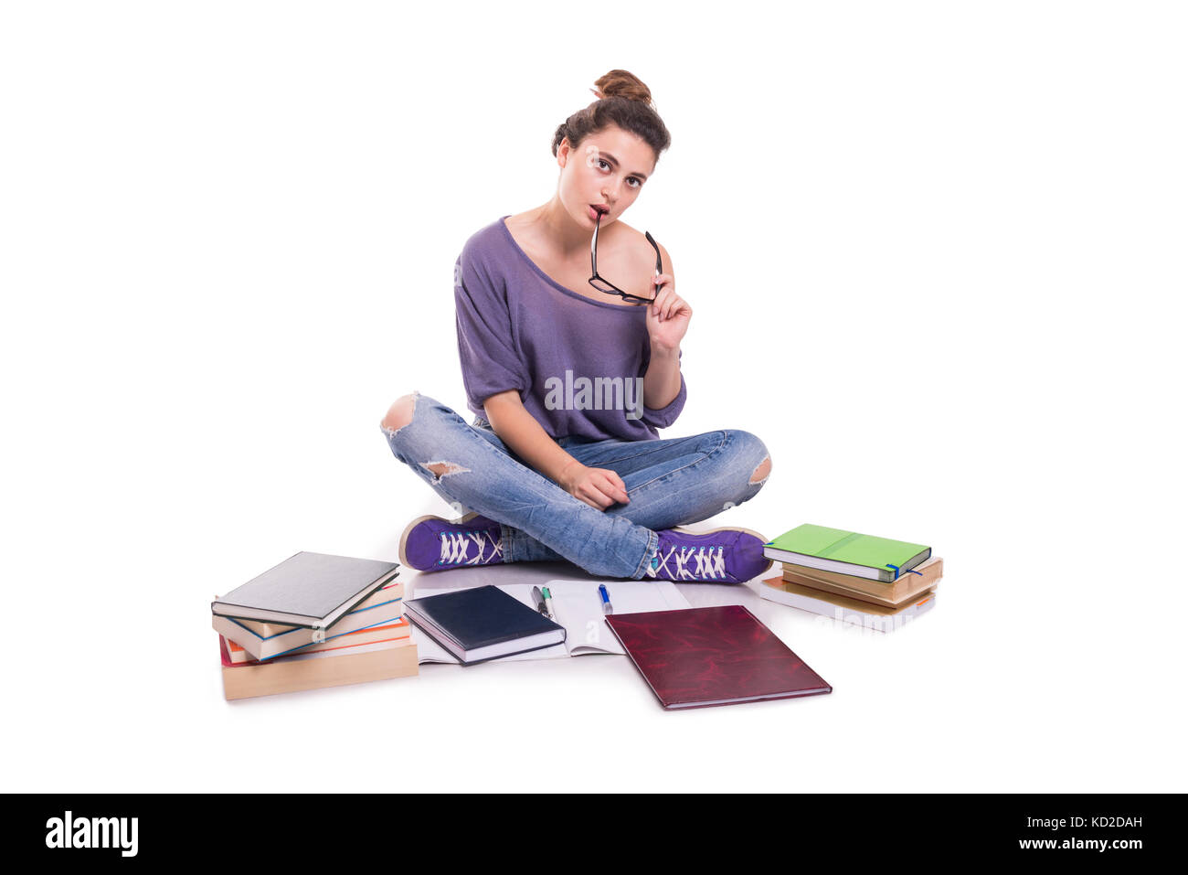 Smart young student with her books reading and taking notes Stock Photo ...