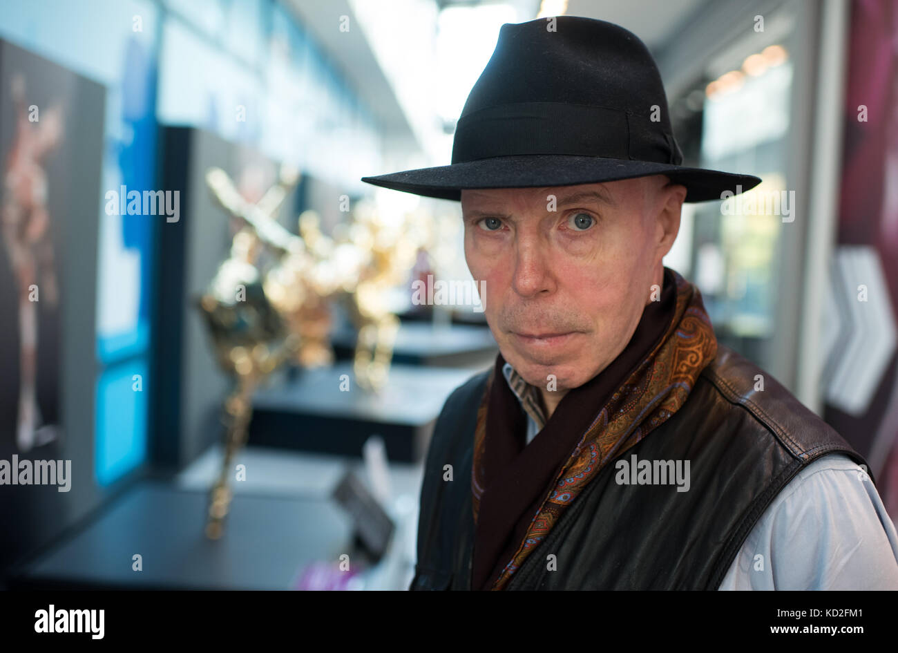 Plastinator Gunther von Hagens standing in front of a gold-plated ...