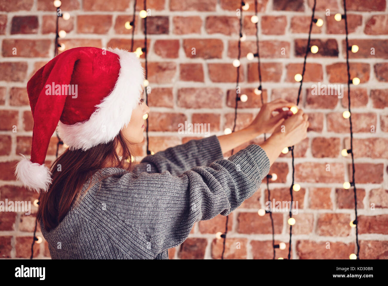 Rear view of woman checking christmas lighting Stock Photo - Alamy