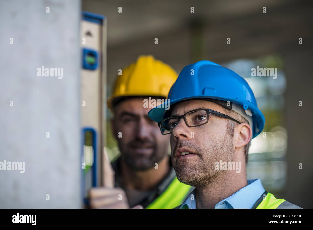 Project manager and construction worker using spirit level Stock Photo ...