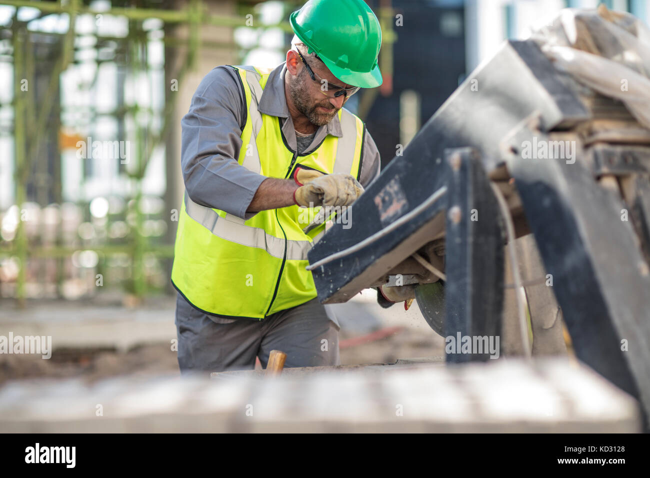 Construction worker using heavy machinery Stock Photo - Alamy