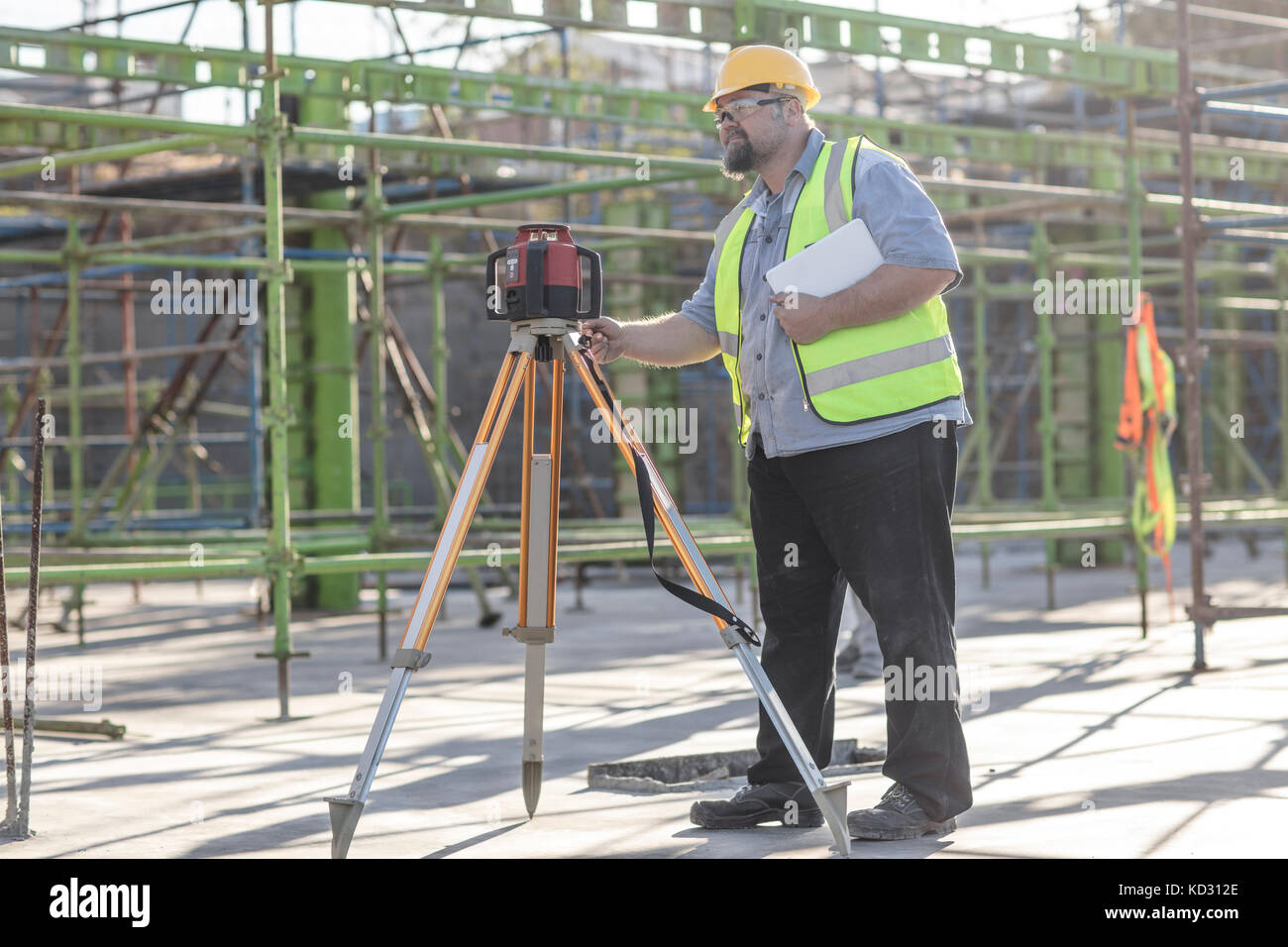 Construction worker using surveying equipment Stock Photo - Alamy