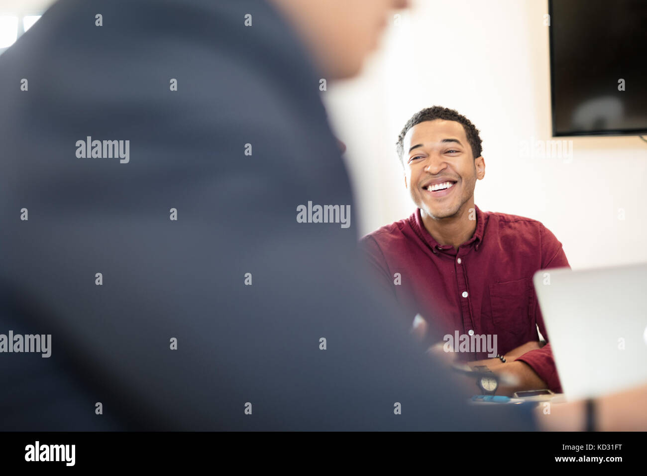 Over shoulder view of young businessman at office desk Stock Photo - Alamy