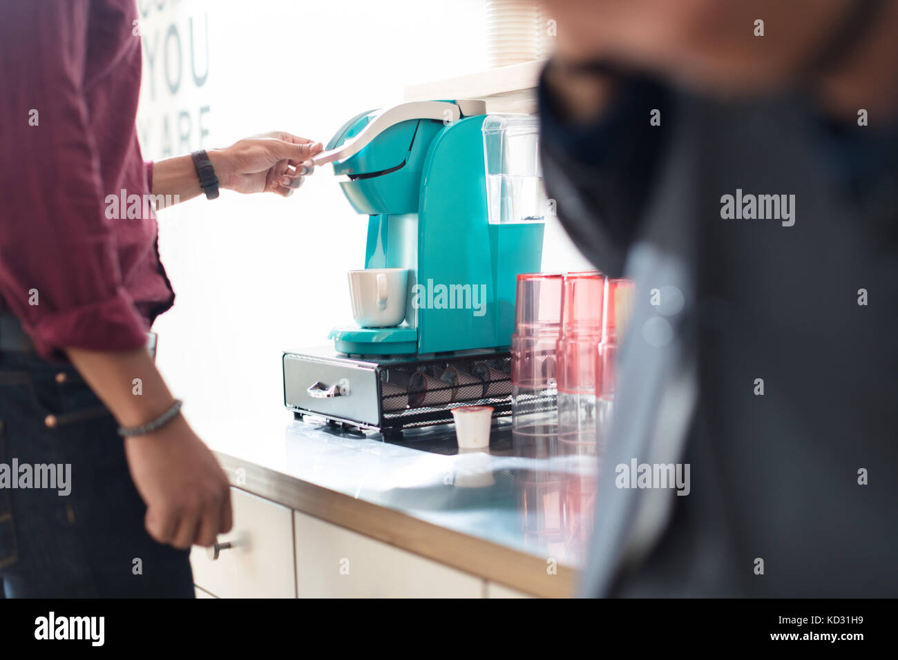 Cropped shot of businessman using coffee machine Stock Photo - Alamy