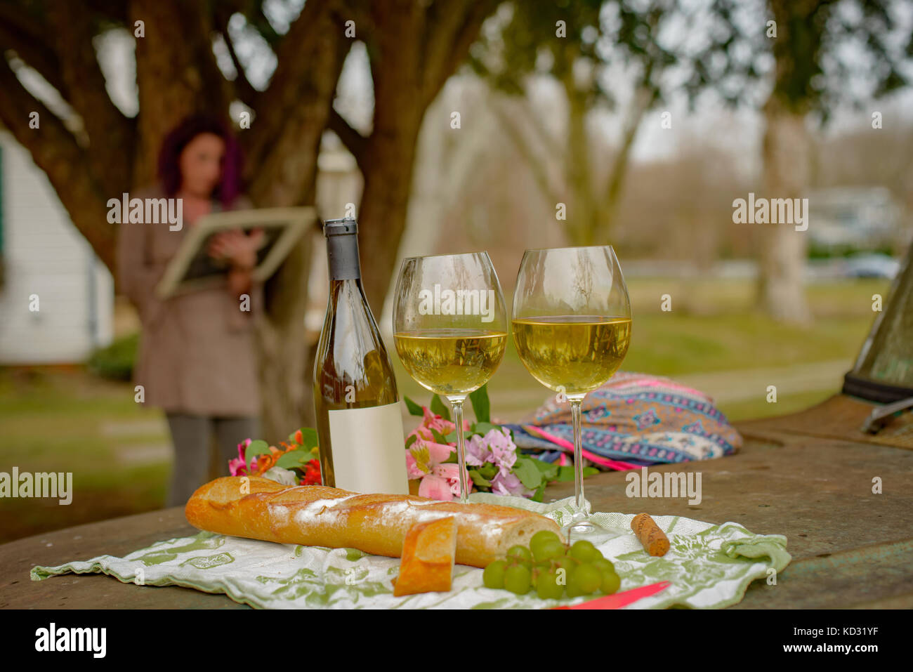 Woman relaxing with wine in garden Stock Photo - Alamy
