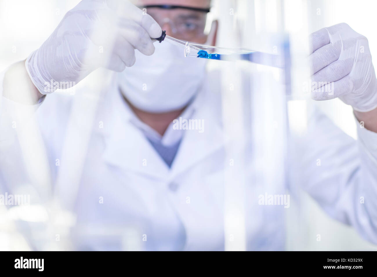 Person holding pipette with test tube hi-res stock photography and ...