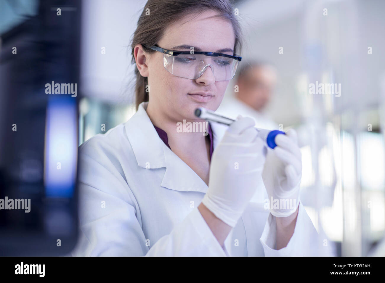 Laboratory worker writing details on test tube Stock Photo - Alamy