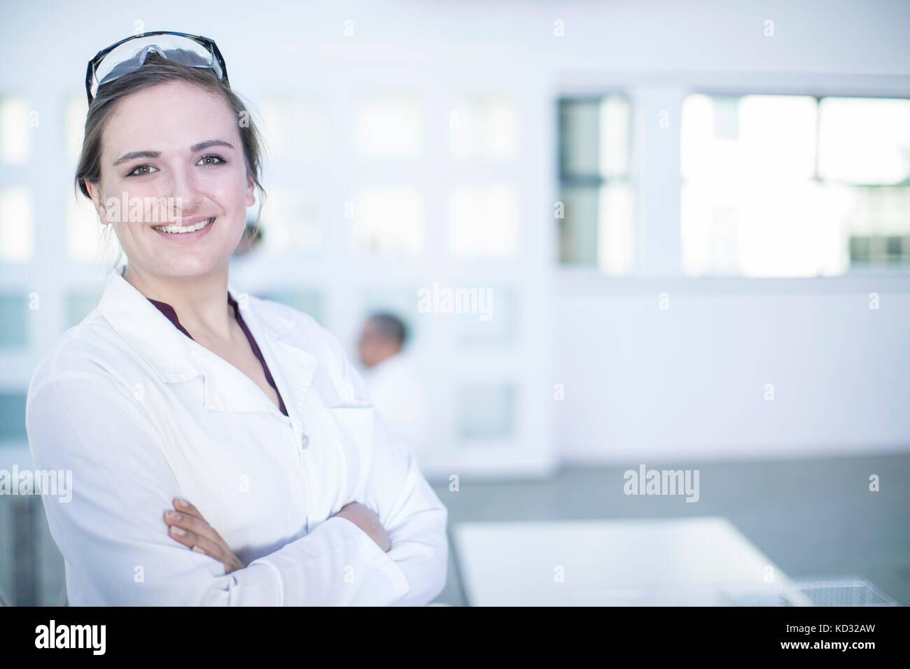 Portrait of female laboratory worker, arms folded, smiling Stock Photo ...