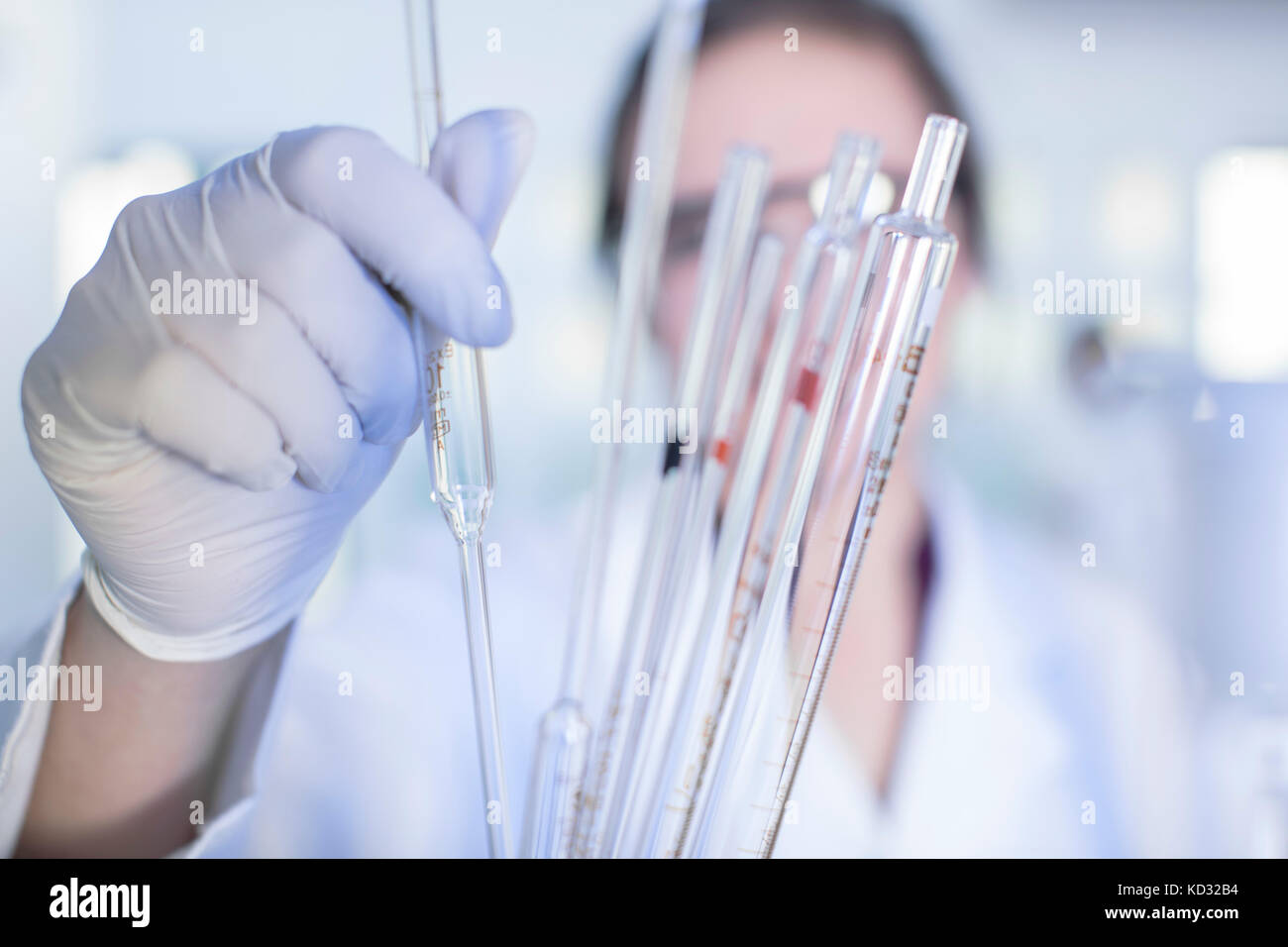 Laboratory worker choosing pipette, close-up Stock Photo - Alamy