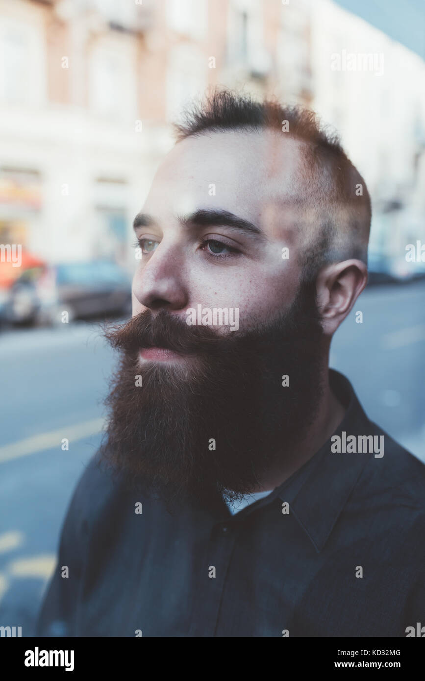 Portrait of bearded man looking away Stock Photo - Alamy