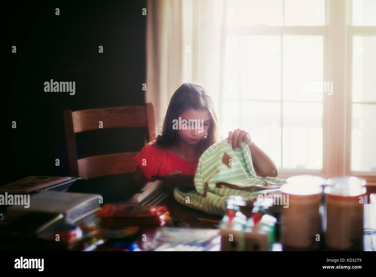 Girl packing backpack with school stationery supplies Stock Photo - Alamy