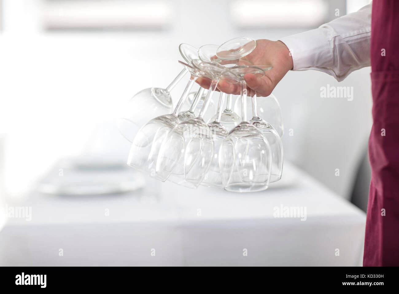 Waiter laying table in restaurant, mid section Stock Photo - Alamy