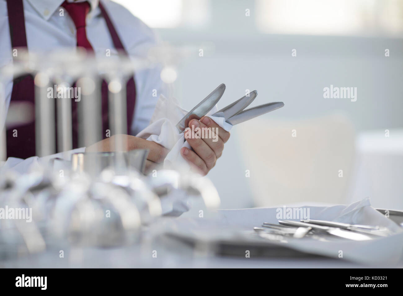 Waiter laying table in restaurant, mid section Stock Photo - Alamy