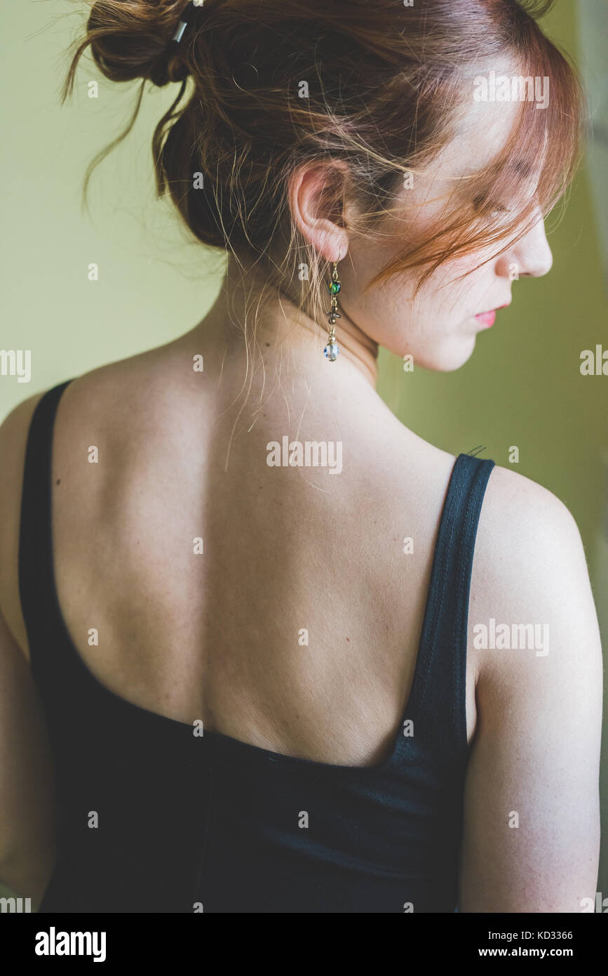 Rear view portrait of young woman looking over her shoulder Stock Photo ...