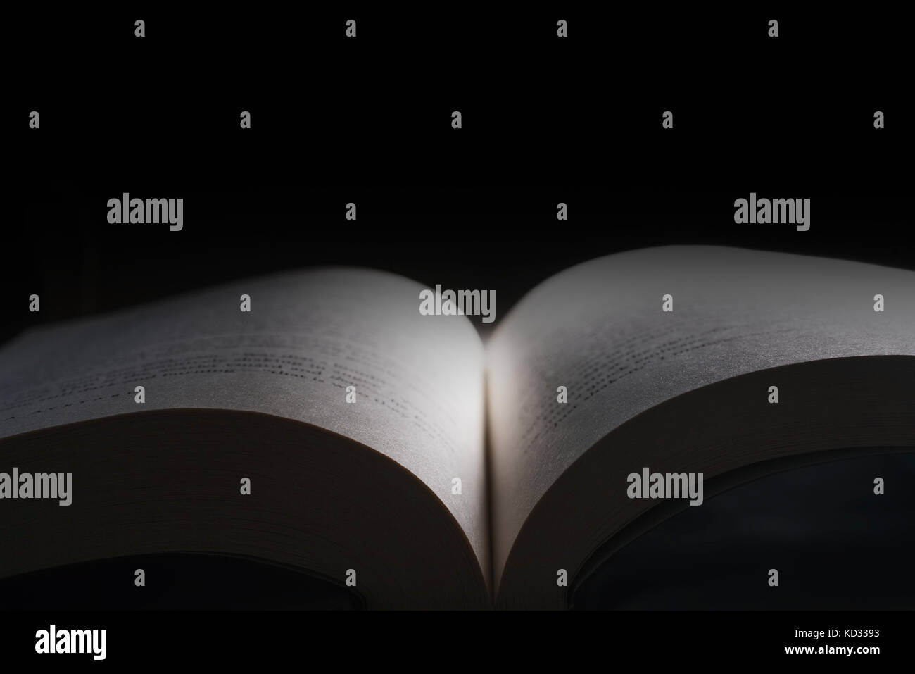 Open book, black background Stock Photo - Alamy