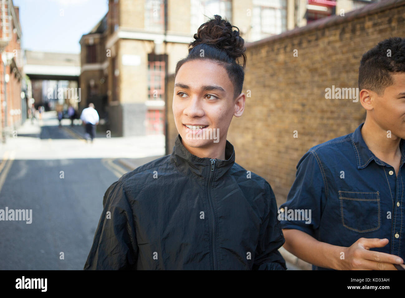 Two young men walking outdoors Stock Photo - Alamy