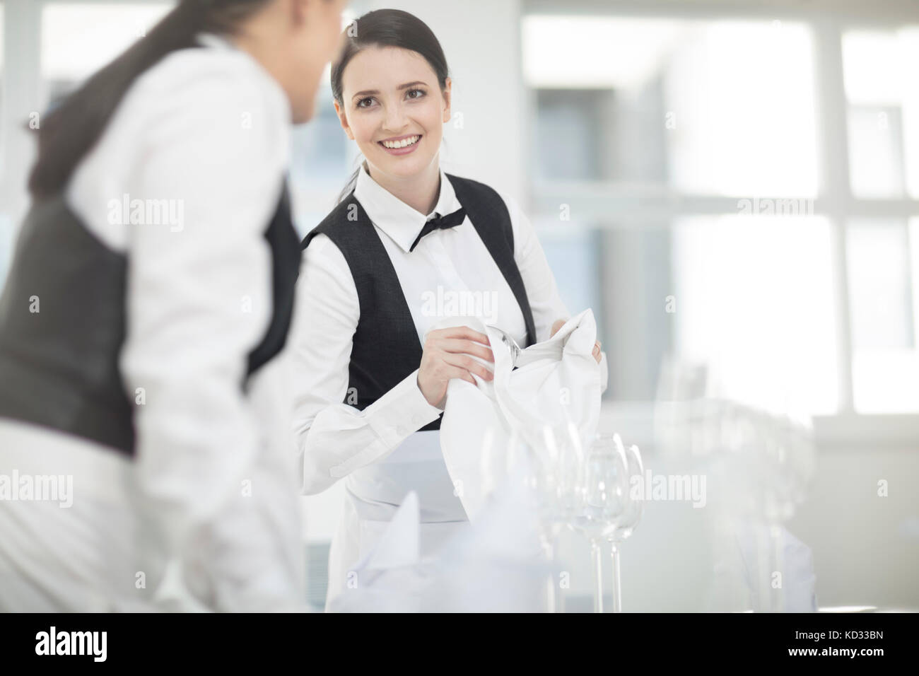 Two waitresses in restaurant, preparing tables Stock Photo - Alamy