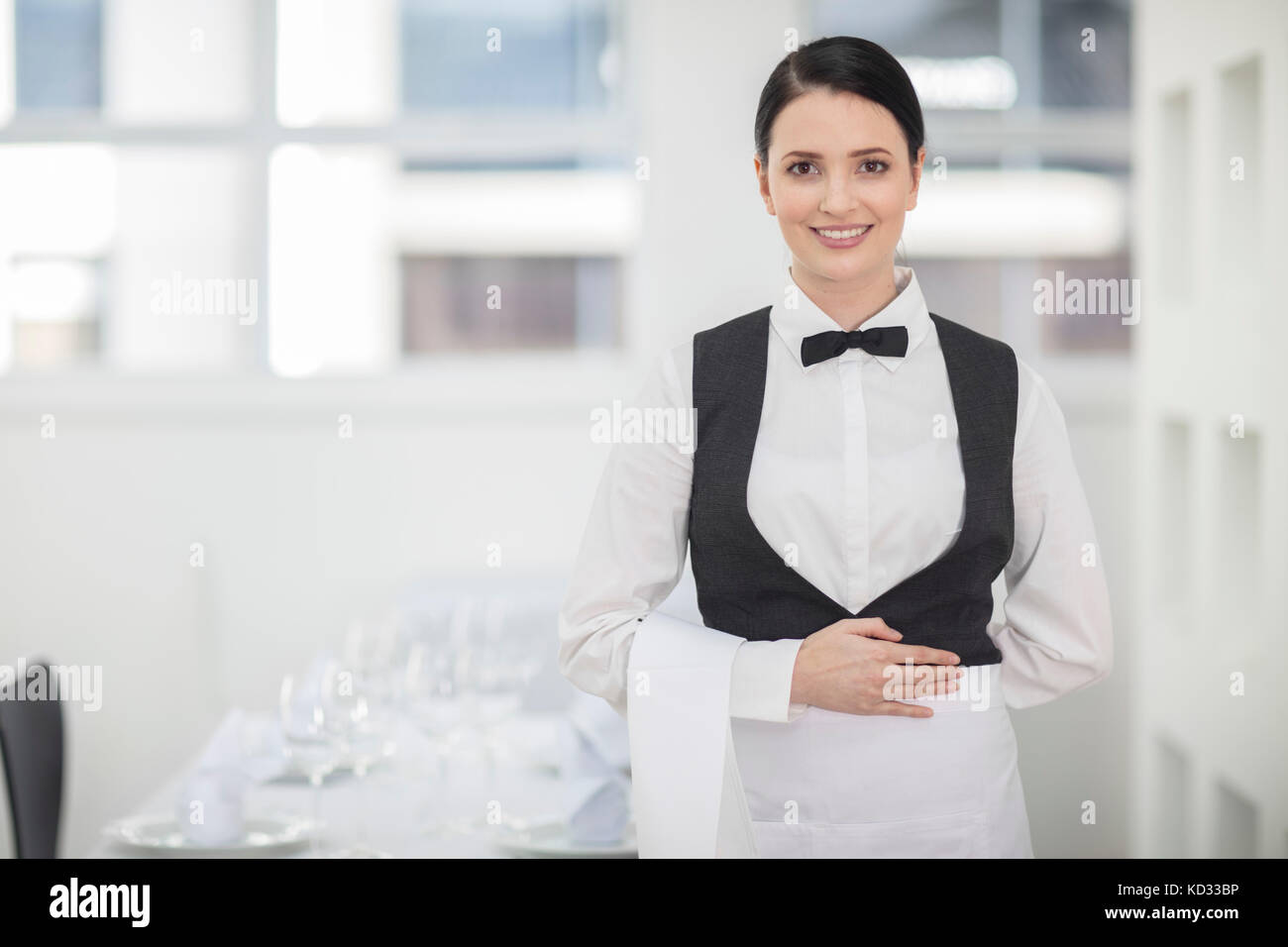 Portrait of waitress in restaurant Stock Photo - Alamy