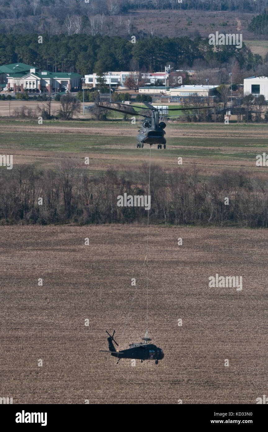 U.S. Soldiers from the S.C. Army National Guard sling load a UH-60 ...