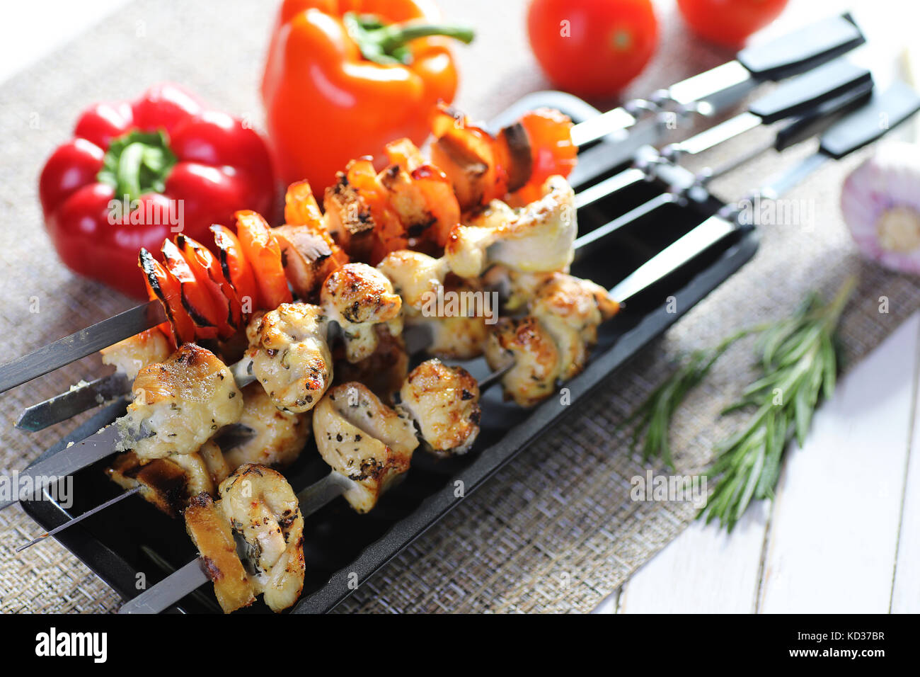 Kebab cooked on metal skewers with vegetables Stock Photo - Alamy