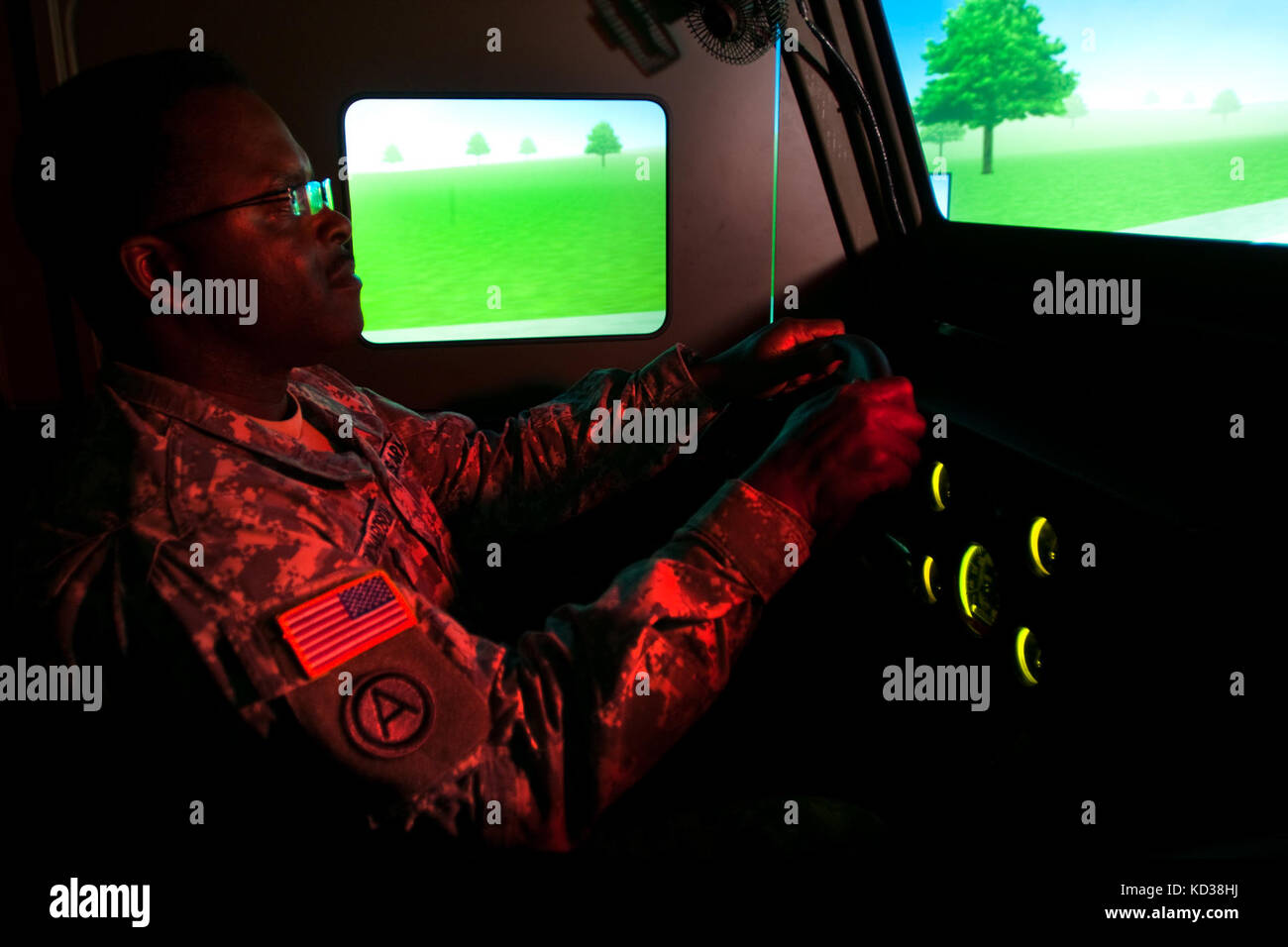 Chief Warrant Officer 3 John Richardson Jr. simulates driving a HMMWV ...