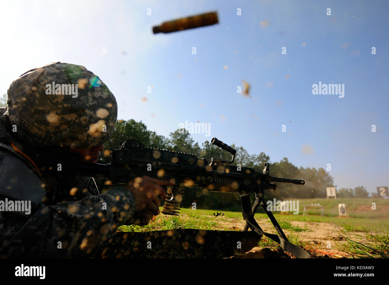 U.S. Army Soldier, Army National Guard, fires an M-249B machine gun, at ...