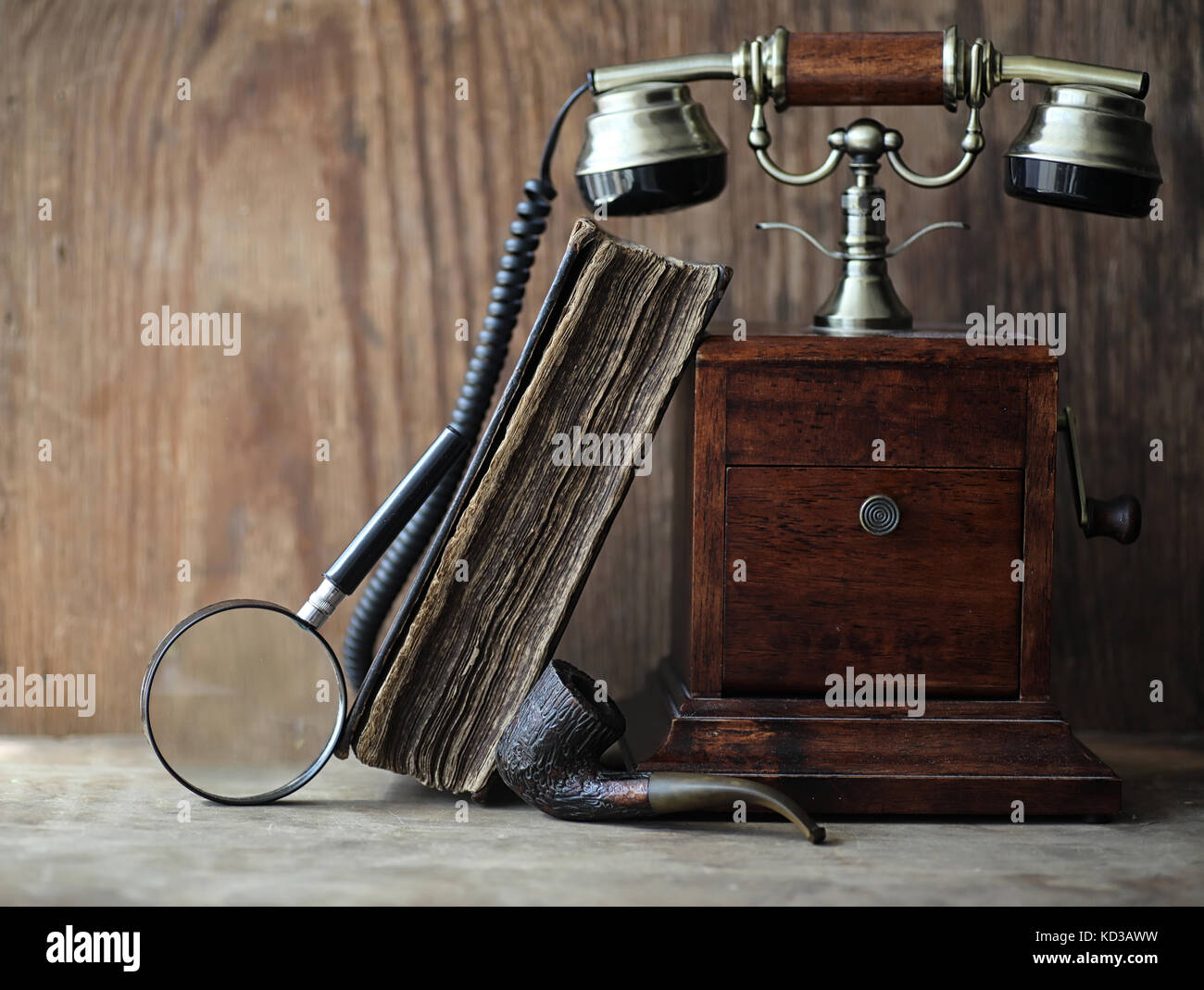 Old telephone and retro book on a wood Stock Photo - Alamy
