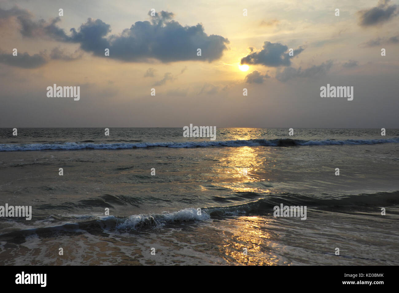 Sunset on the Arabian Sea with the reflection of the sun on the wet ...