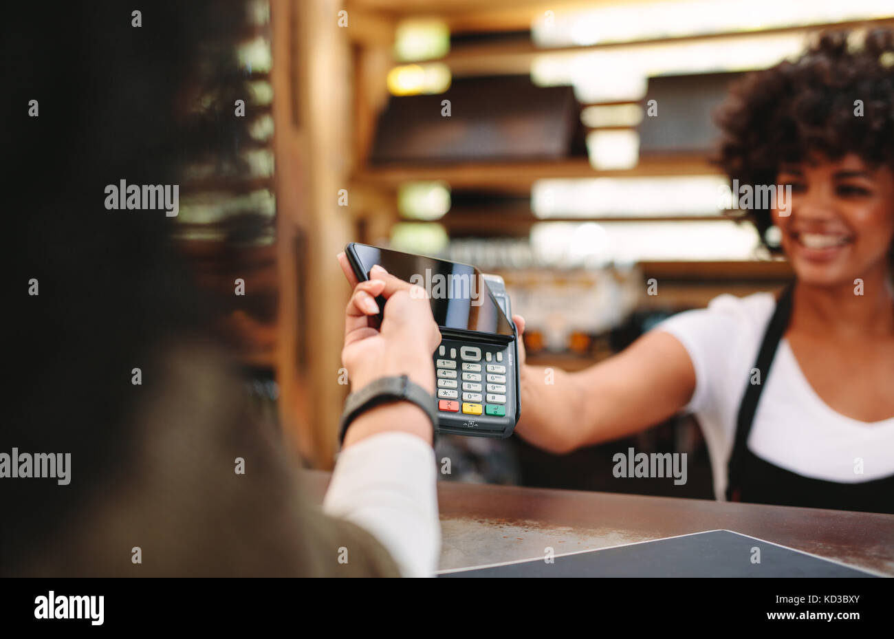 Customer making wireless or contactless payment using smartphone ...