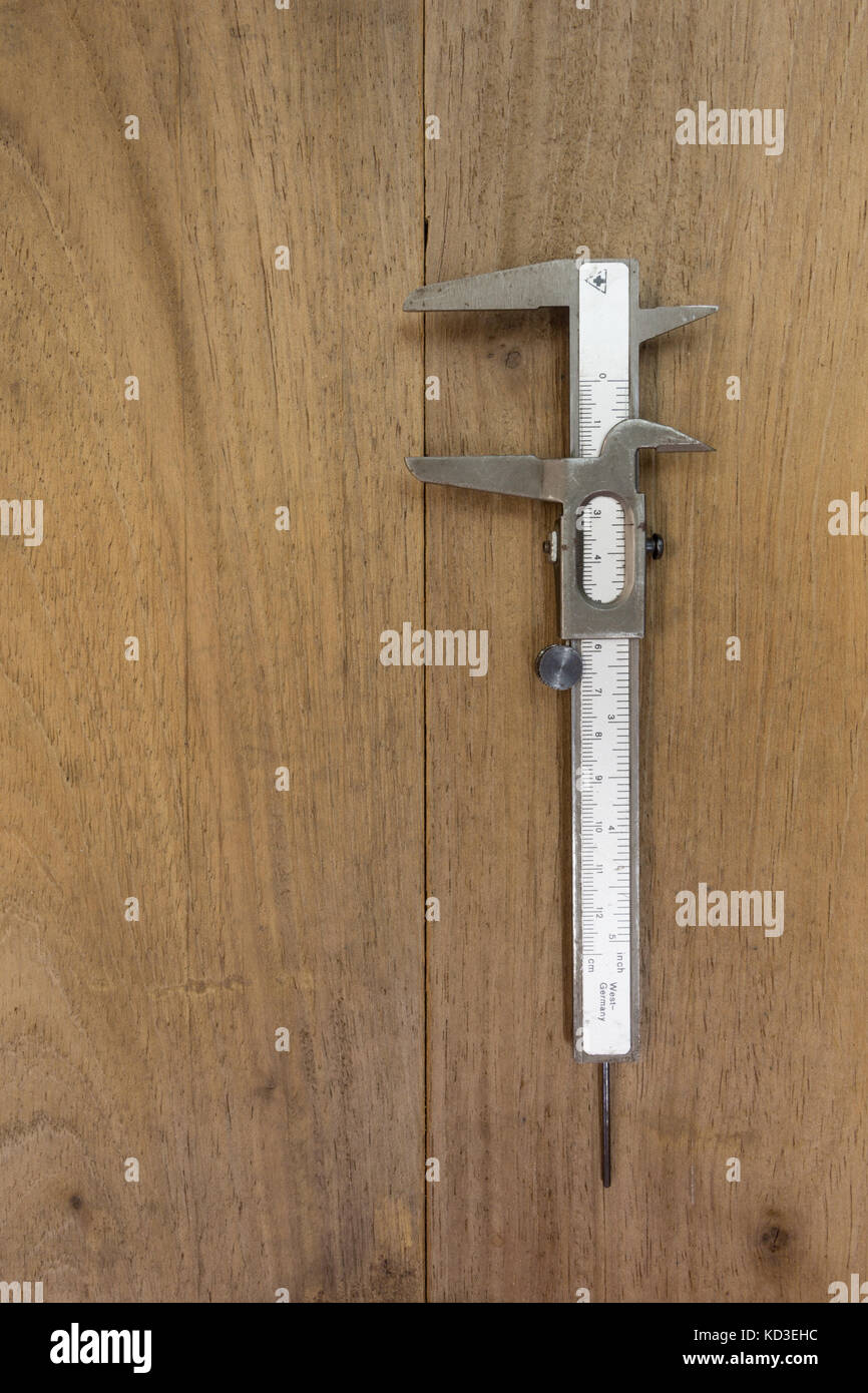 Vernier caliper on wooden background, flat lay Stock Photo - Alamy
