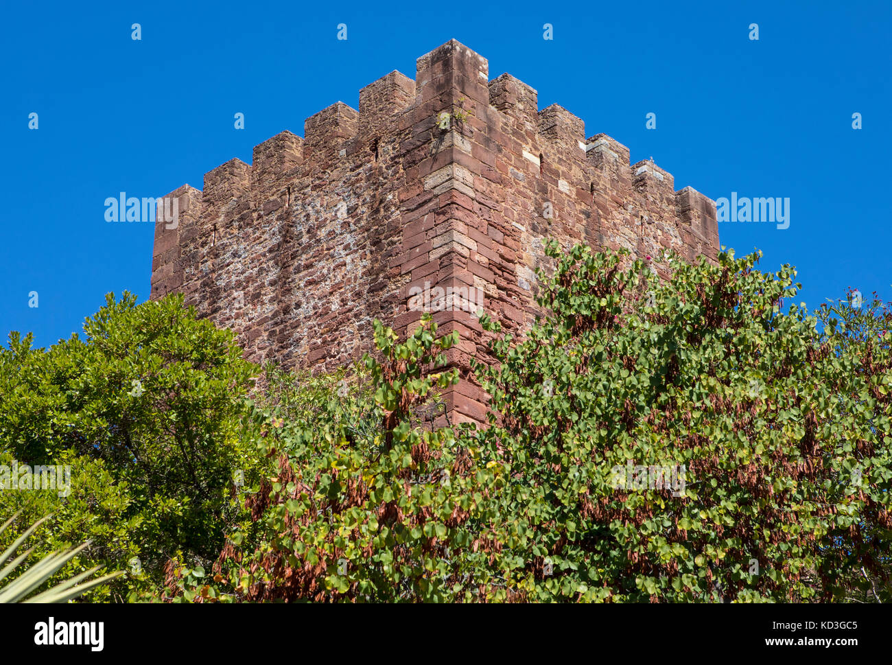 Looking up at one of the imposing towers of Silves Castle in the ...