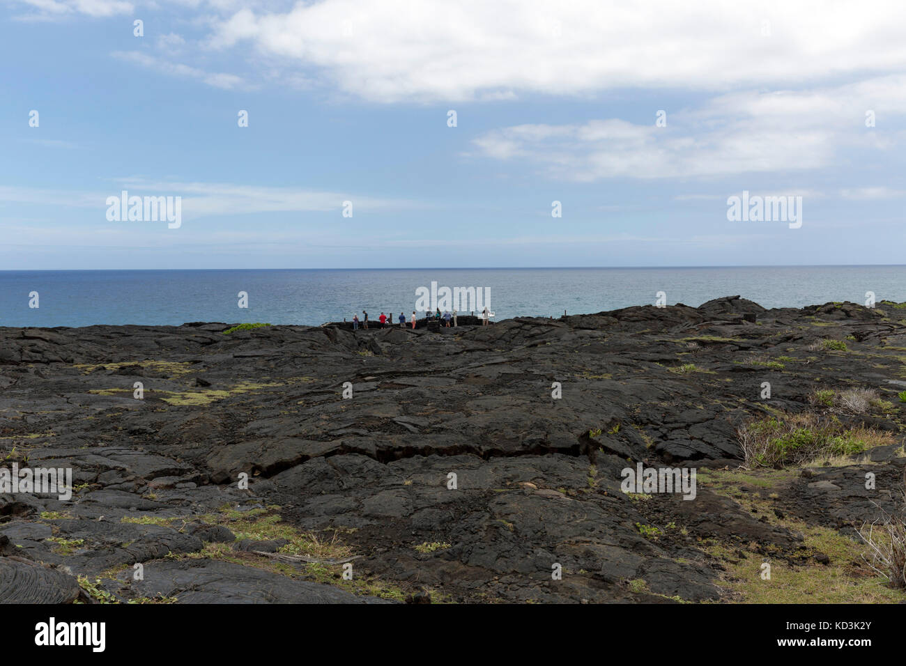 Tourists on the edge of a lava cliff in Volcanoes National Park, Hawaii ...