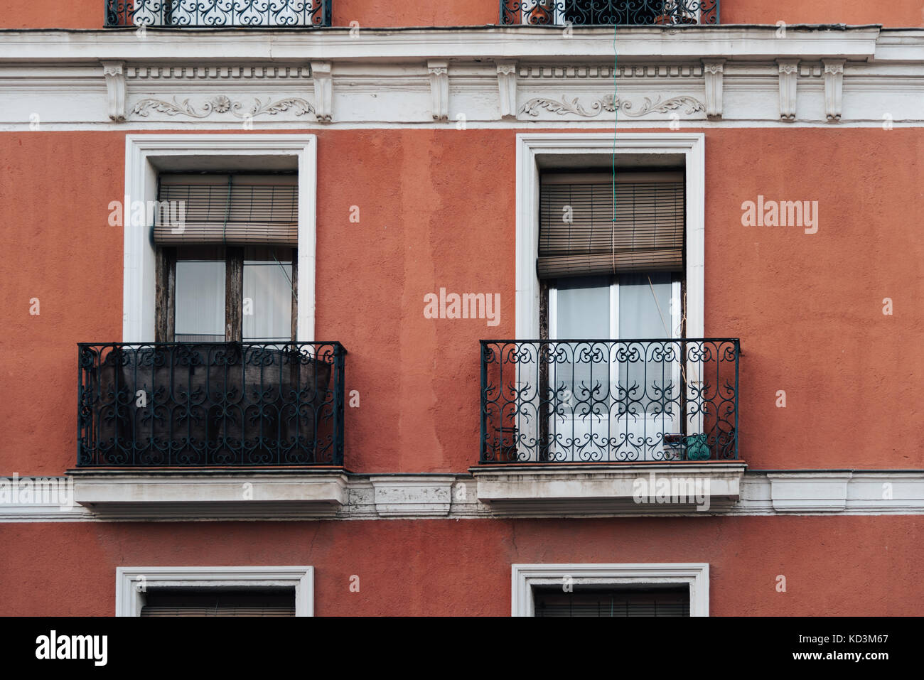 Madrid, Spain - May 1, 2017: Red painted facade of classic residential ...