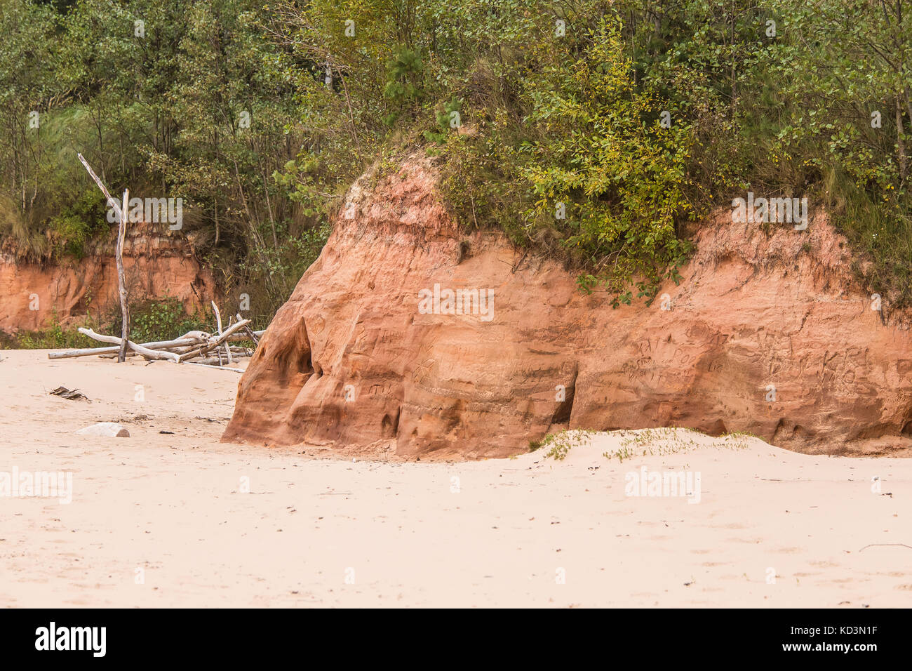 A beautiful seaside landscape with a sandstone caves. Orange sandstone ...
