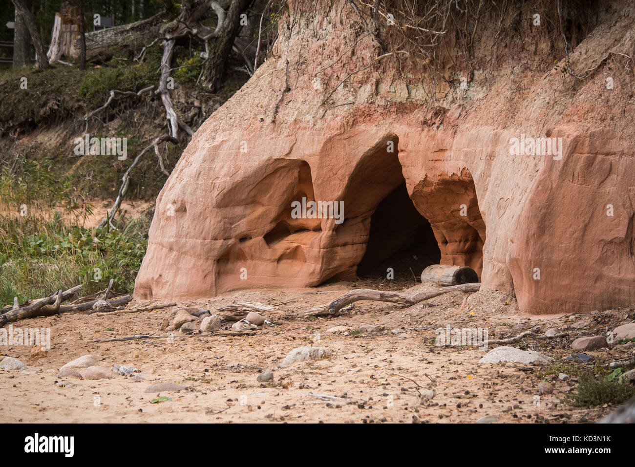 A beautiful seaside landscape with a sandstone caves. Orange sandstone ...