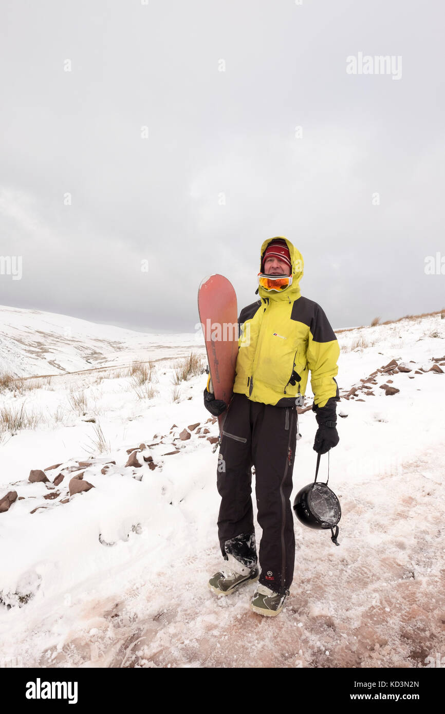 Snowboarder descending Pen Y Fan in Breacon Beacons during heavy snow ...